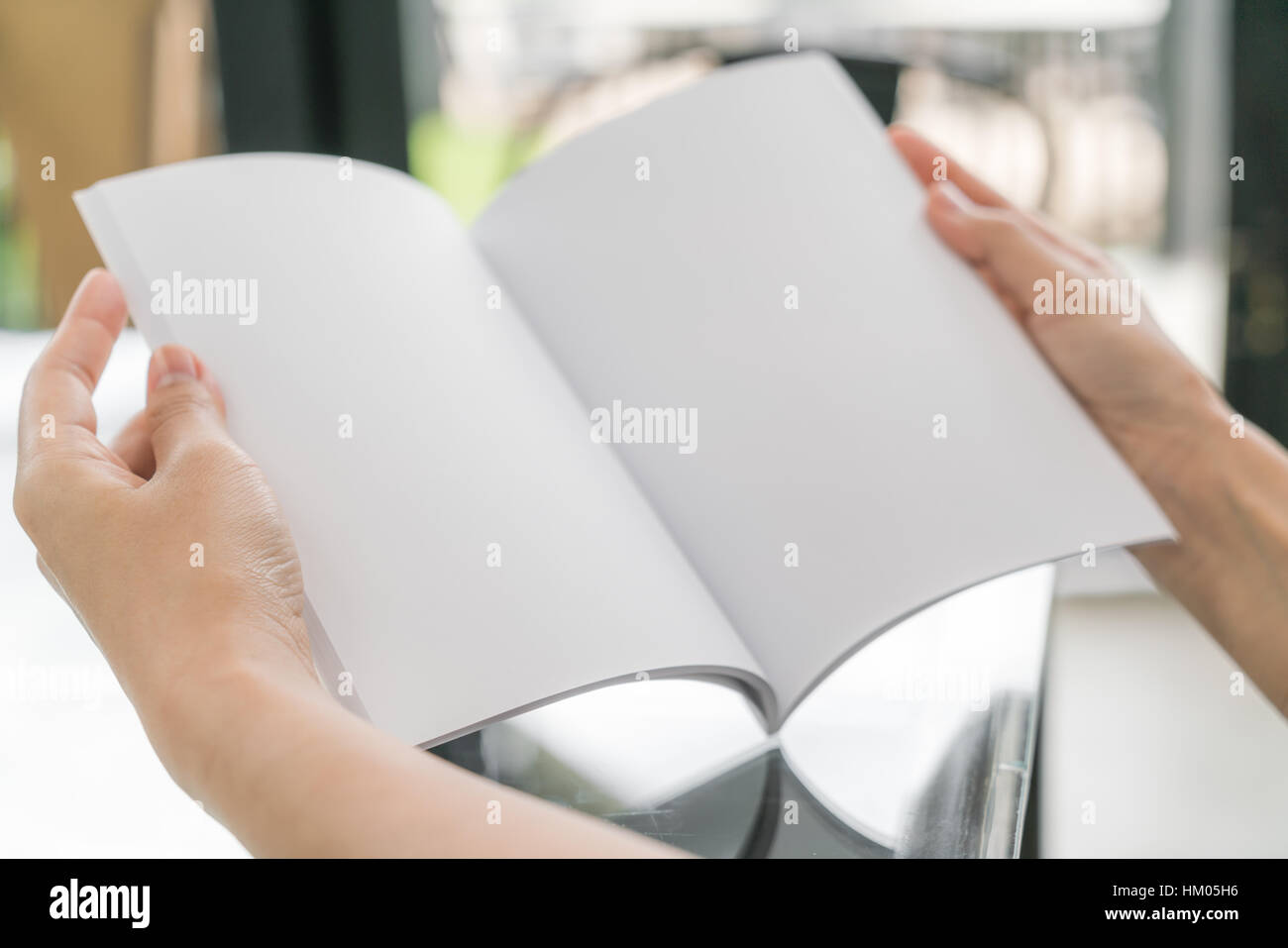 Hands open book on table Stock Photo - Alamy