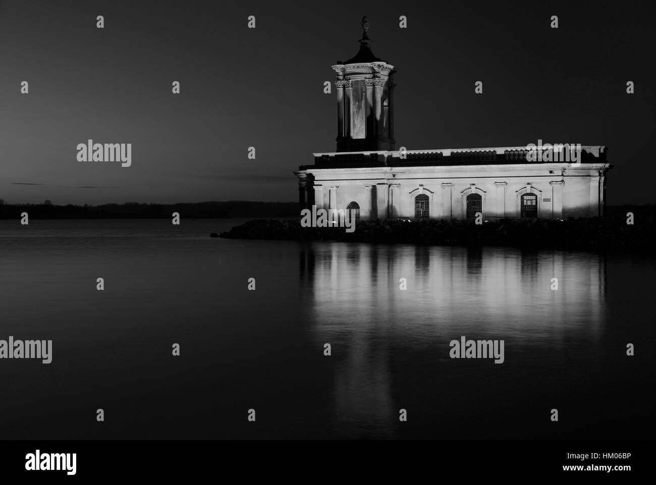 Normanton church illuminated at night and reflected in Rutland Water ...