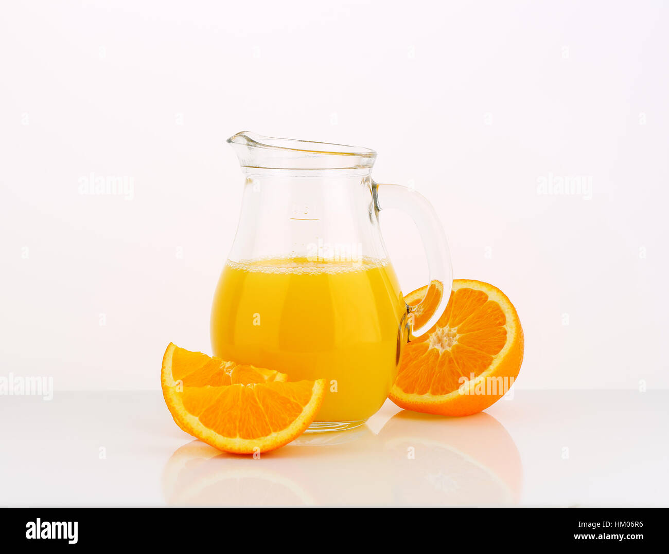 jug of fresh orange juice on white background Stock Photo - Alamy