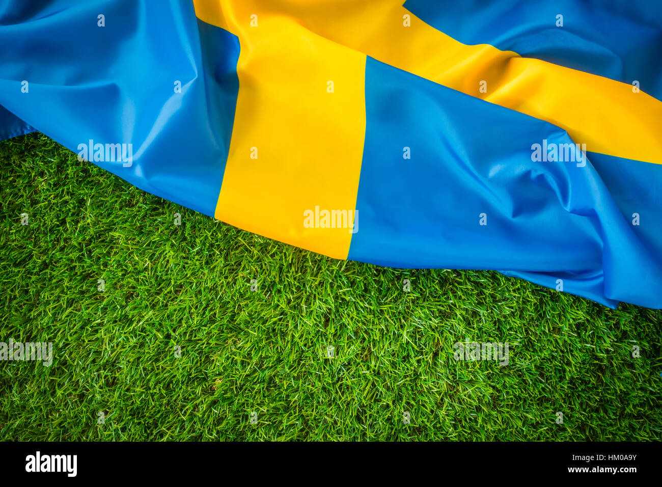 Flags of Sweden on green grass Stock Photo - Alamy