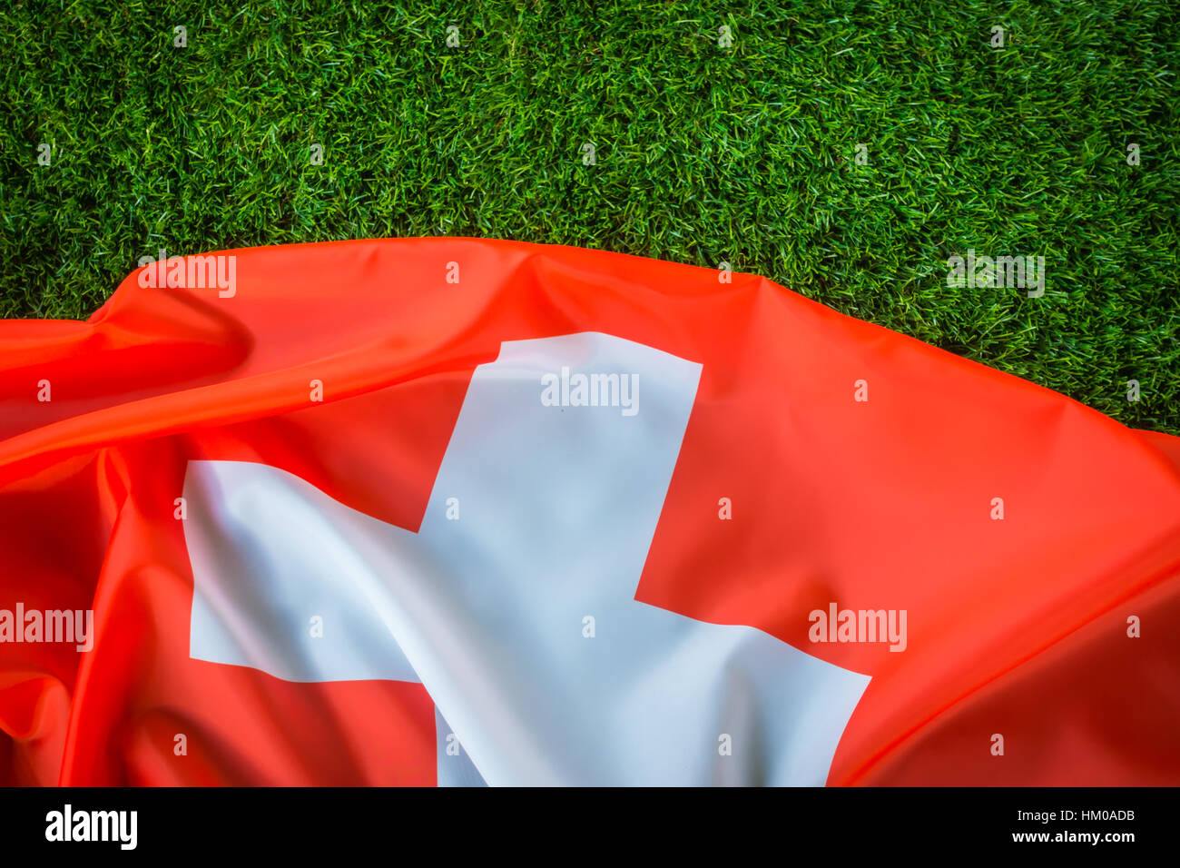 Flags of Switzerland on green grass Stock Photo - Alamy