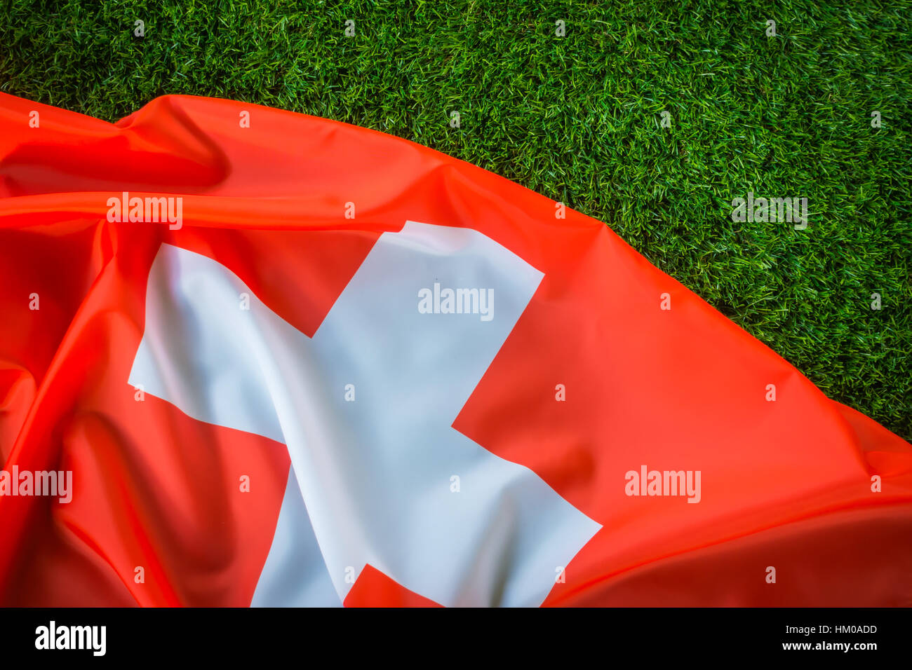 Flags of Switzerland on green grass Stock Photo - Alamy