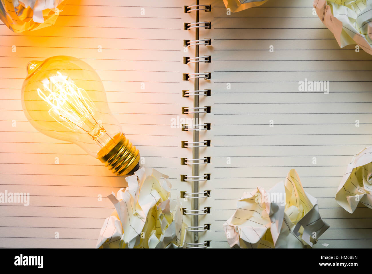 Note book and light bulb Stock Photo - Alamy