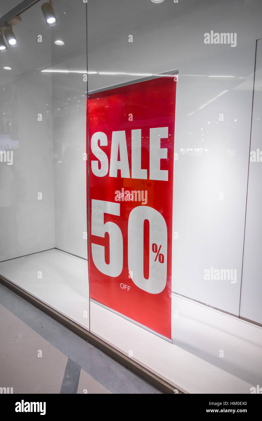 Red store discount sign on a shop window Stock Photo - Alamy