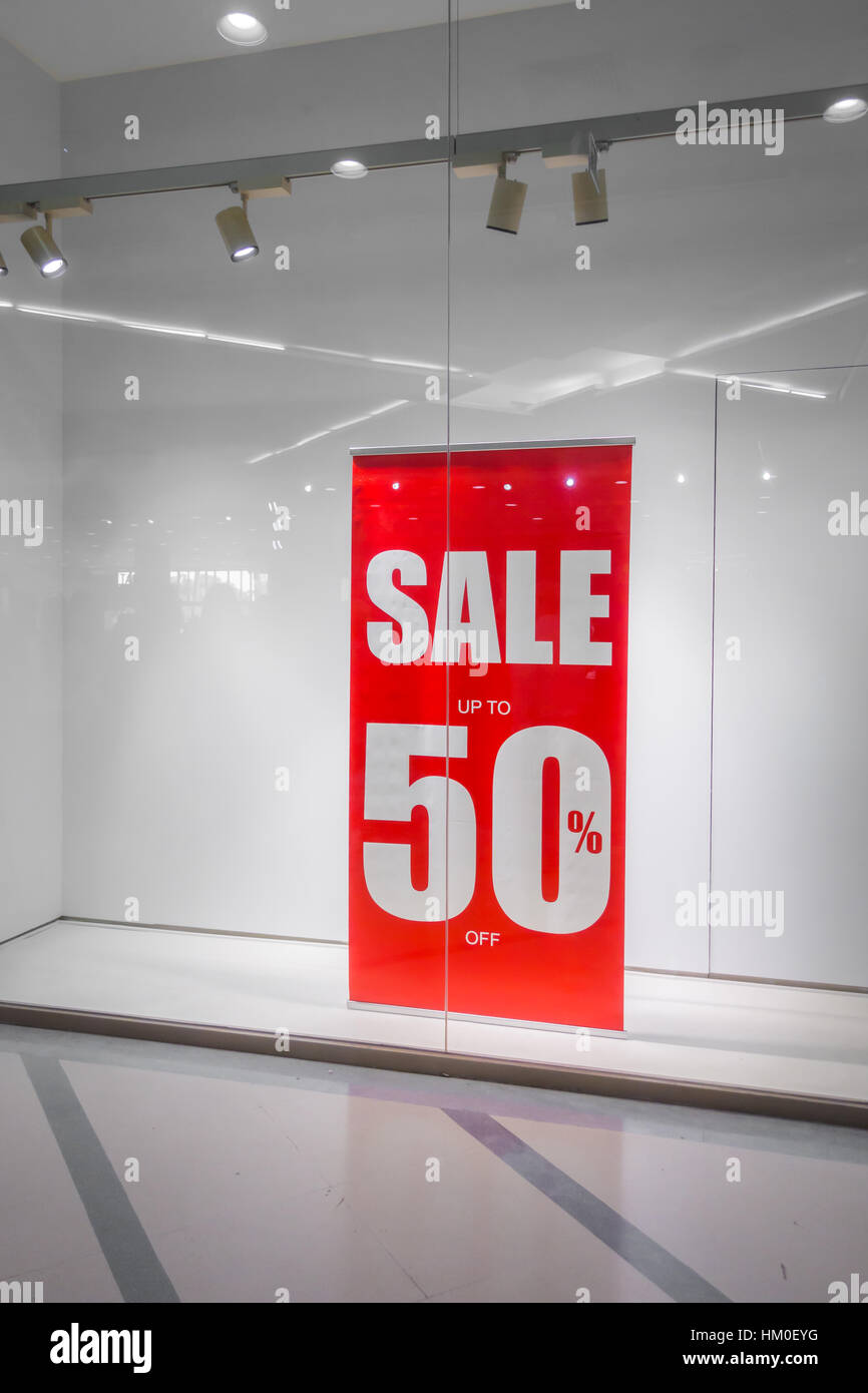Red store discount sign on a shop window Stock Photo - Alamy