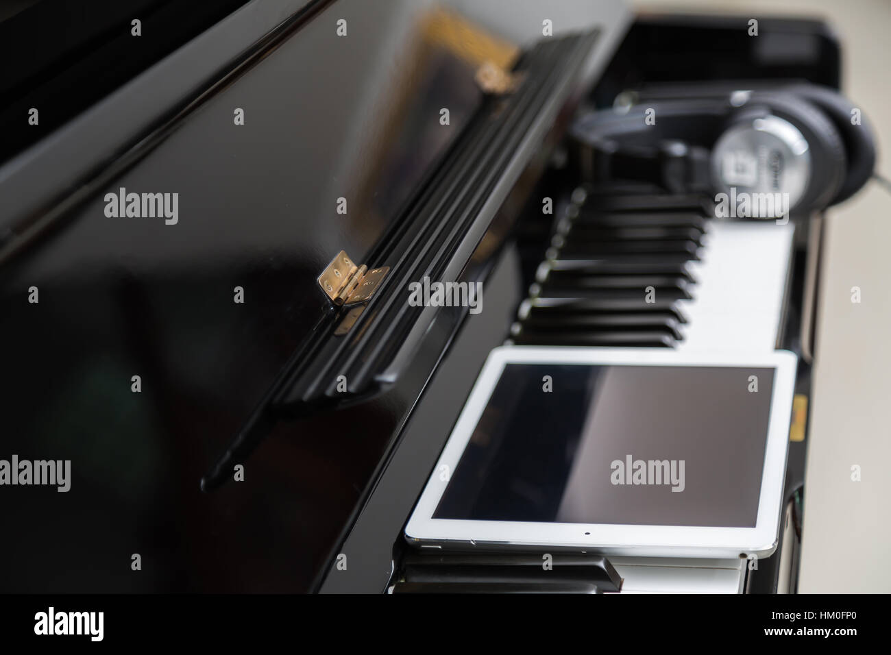 Tablet and head phones on Piano keys Stock Photo - Alamy