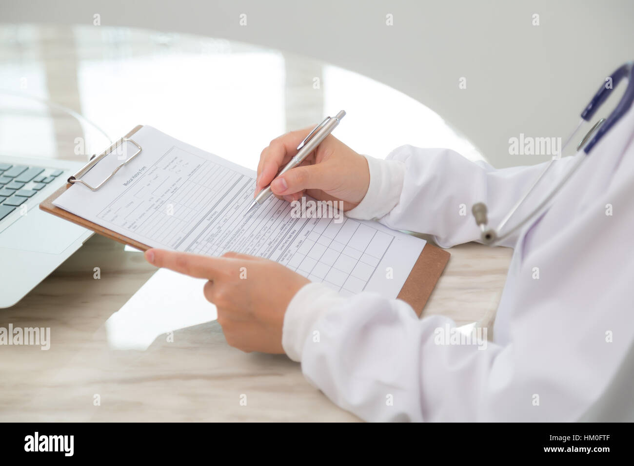 Hand of doctor writing on prescription Stock Photo - Alamy