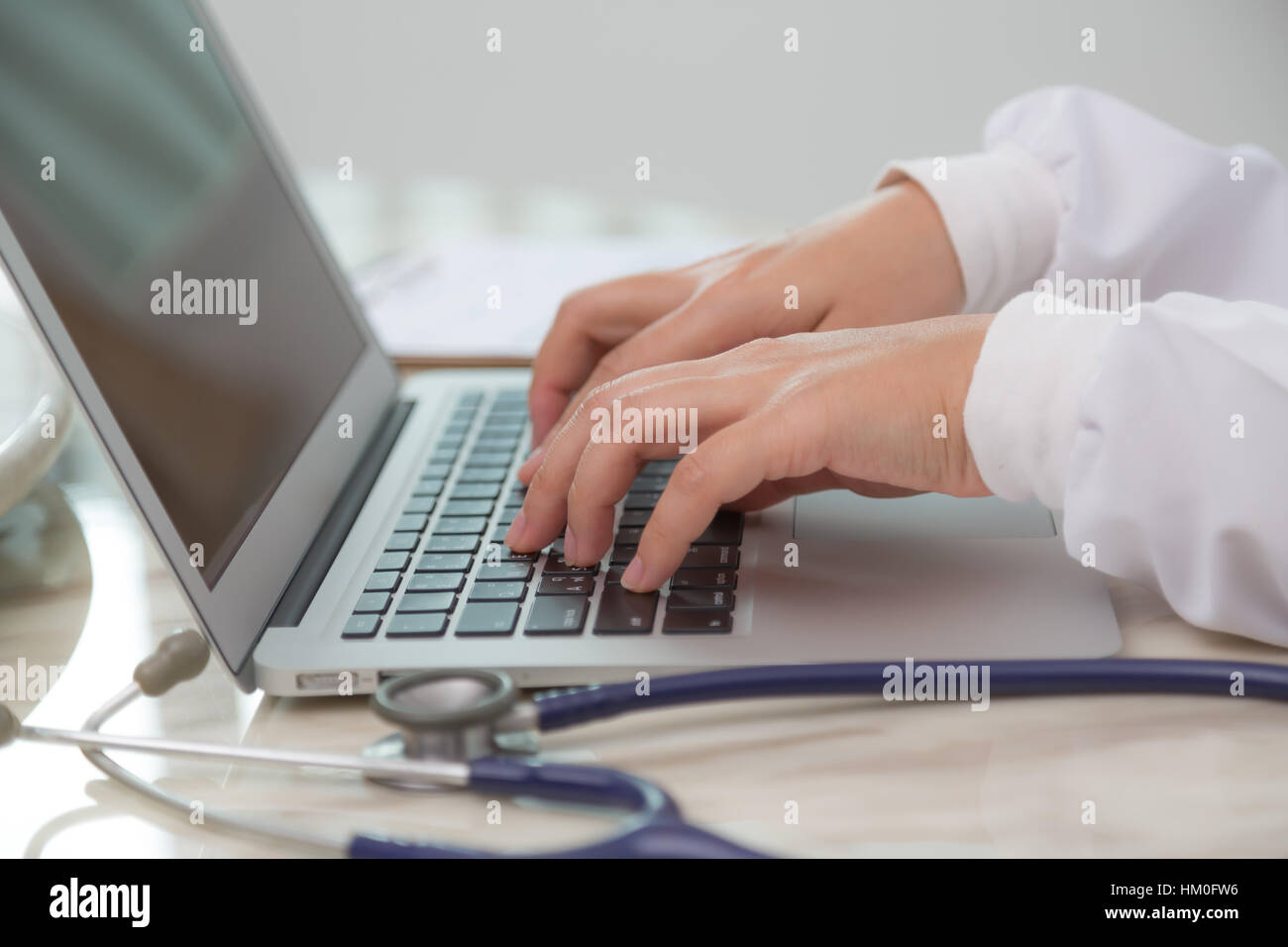 Doctor hands typing on laptop keyboard Stock Photo - Alamy