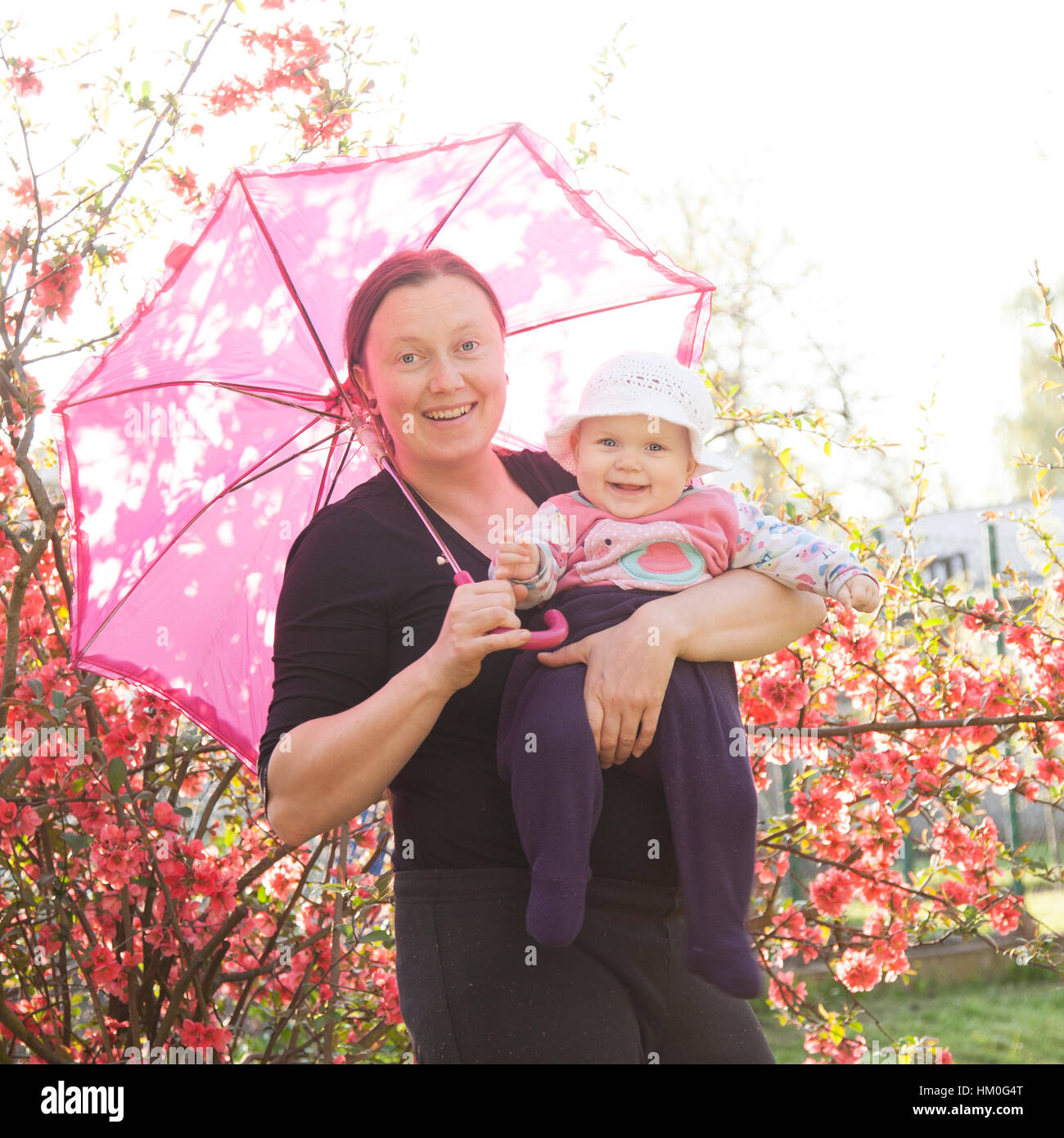 Mammy and baby in pink. Happy smiles Stock Photo - Alamy
