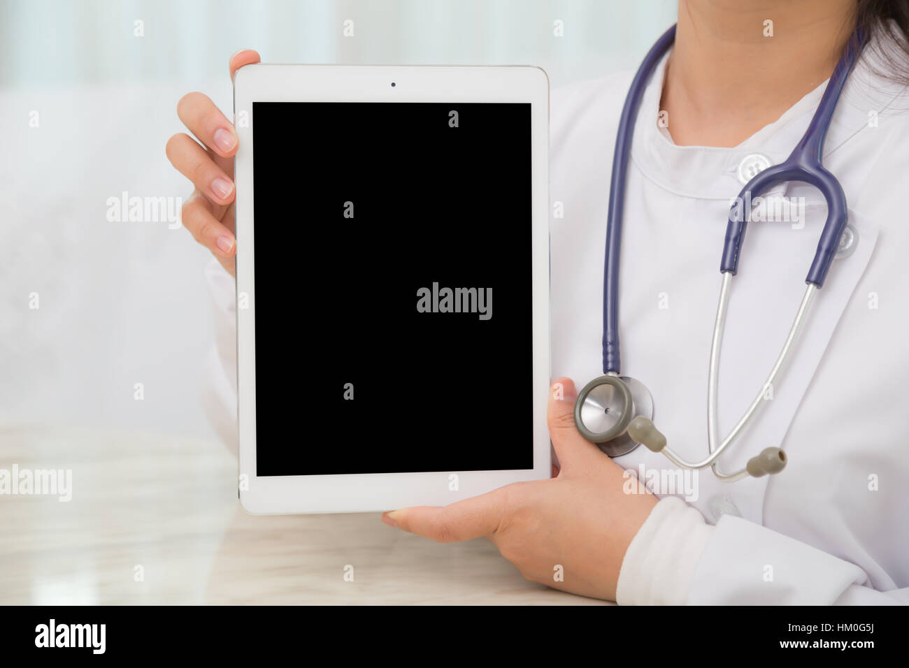 Doctor using tablet computer Stock Photo - Alamy