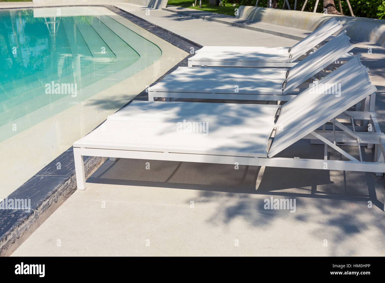 Swimming pool with relaxing seats Stock Photo - Alamy