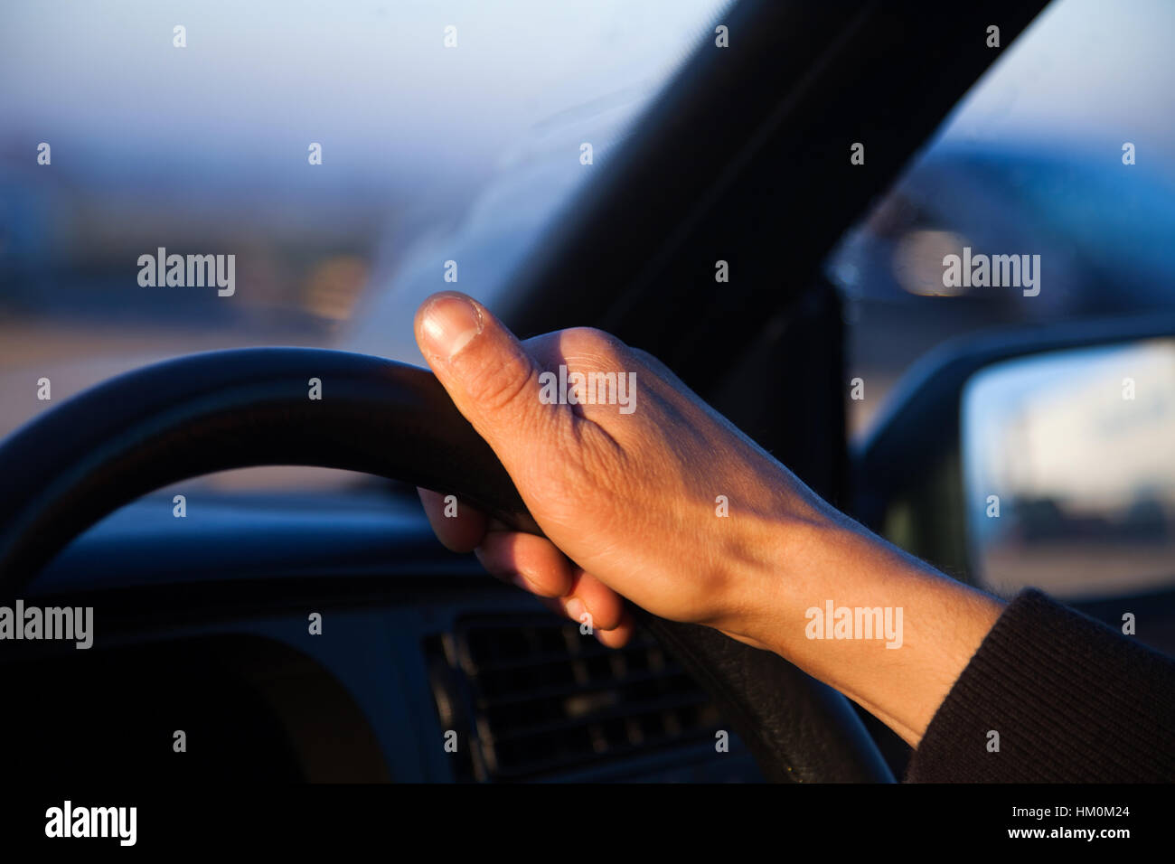 male hands on wheel driving a car Stock Photo - Alamy