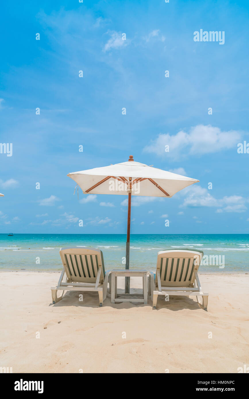 Beautiful beach chairs with umbrella on tropical white sand beach Stock ...