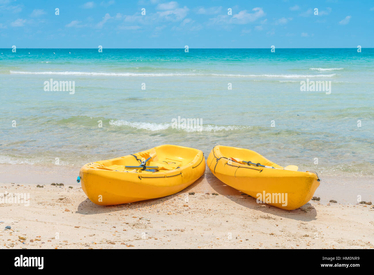 Yellow kayaks on white sand beach Stock Photo - Alamy