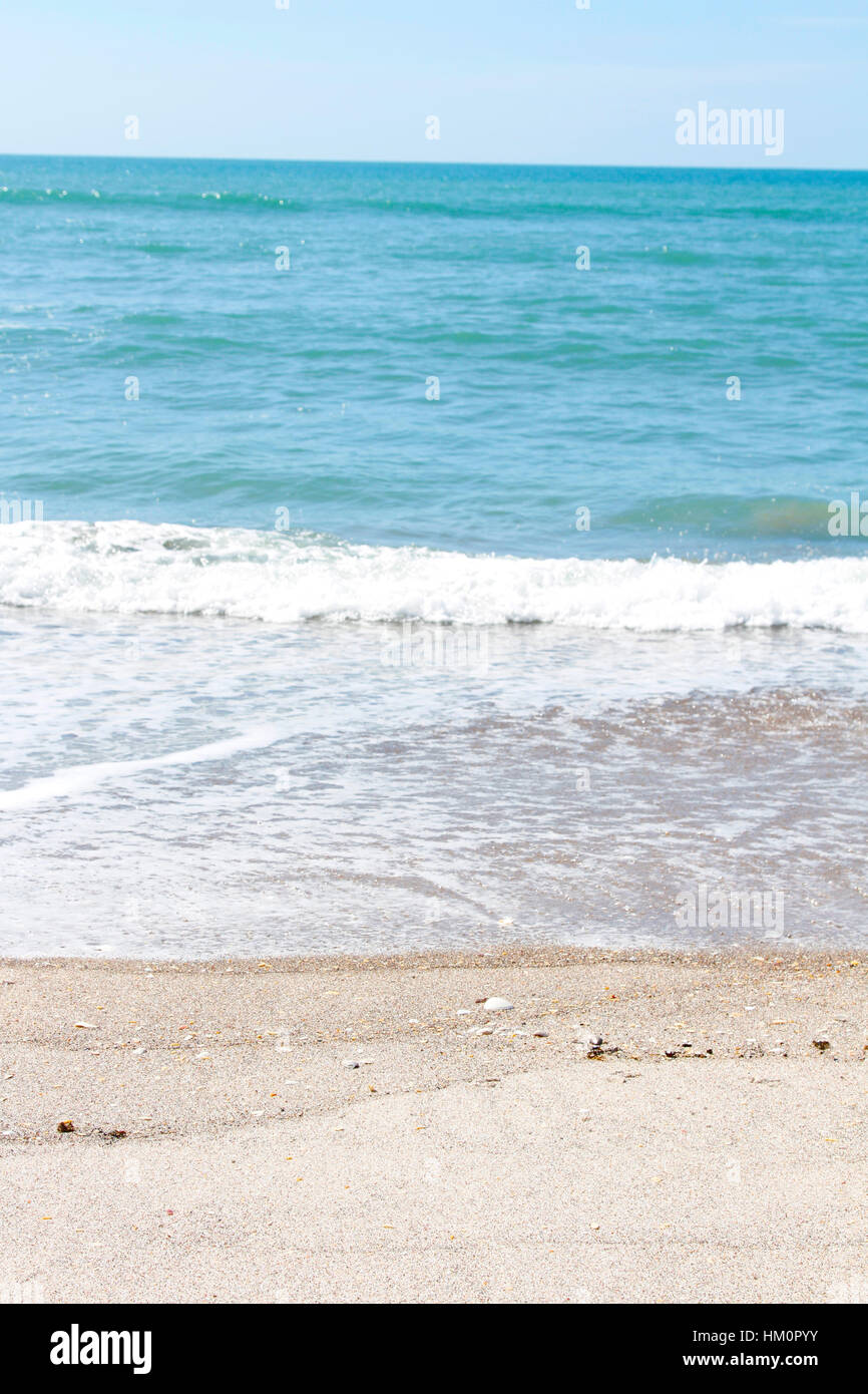 Sandy beach and blue water Stock Photo - Alamy