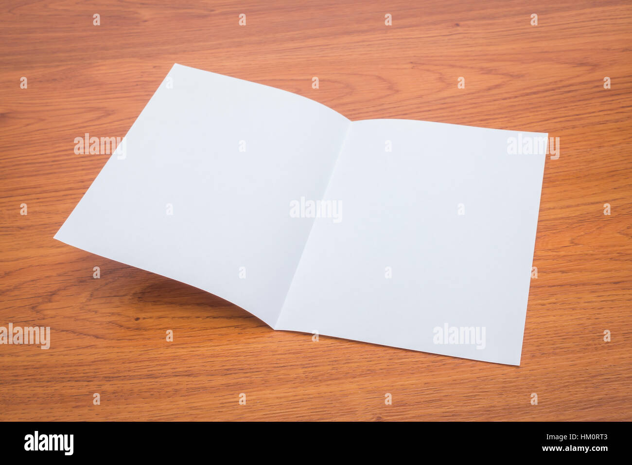 Bifold white template paper on wood texture Stock Photo - Alamy