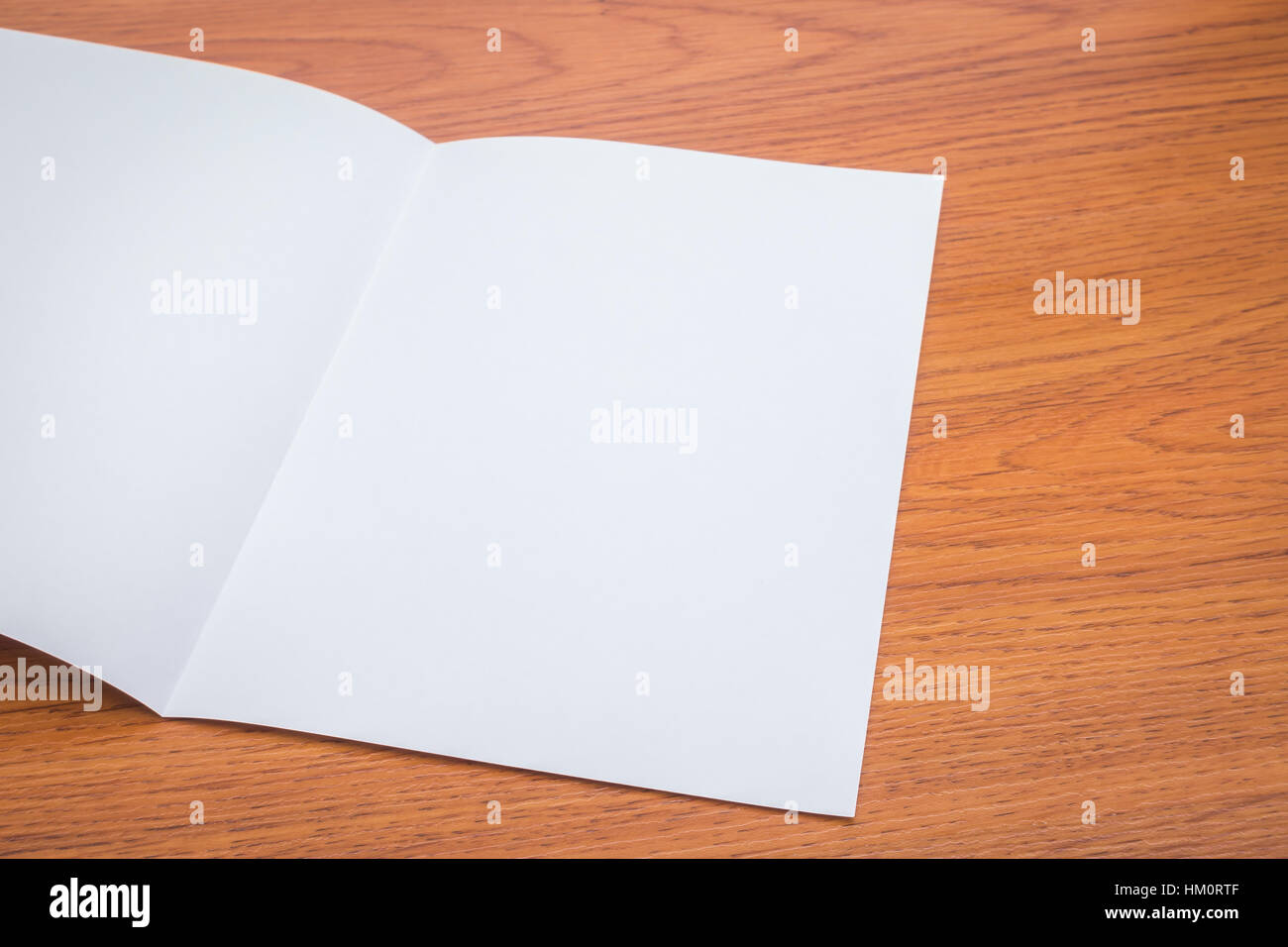 Bifold white template paper on wood texture Stock Photo - Alamy
