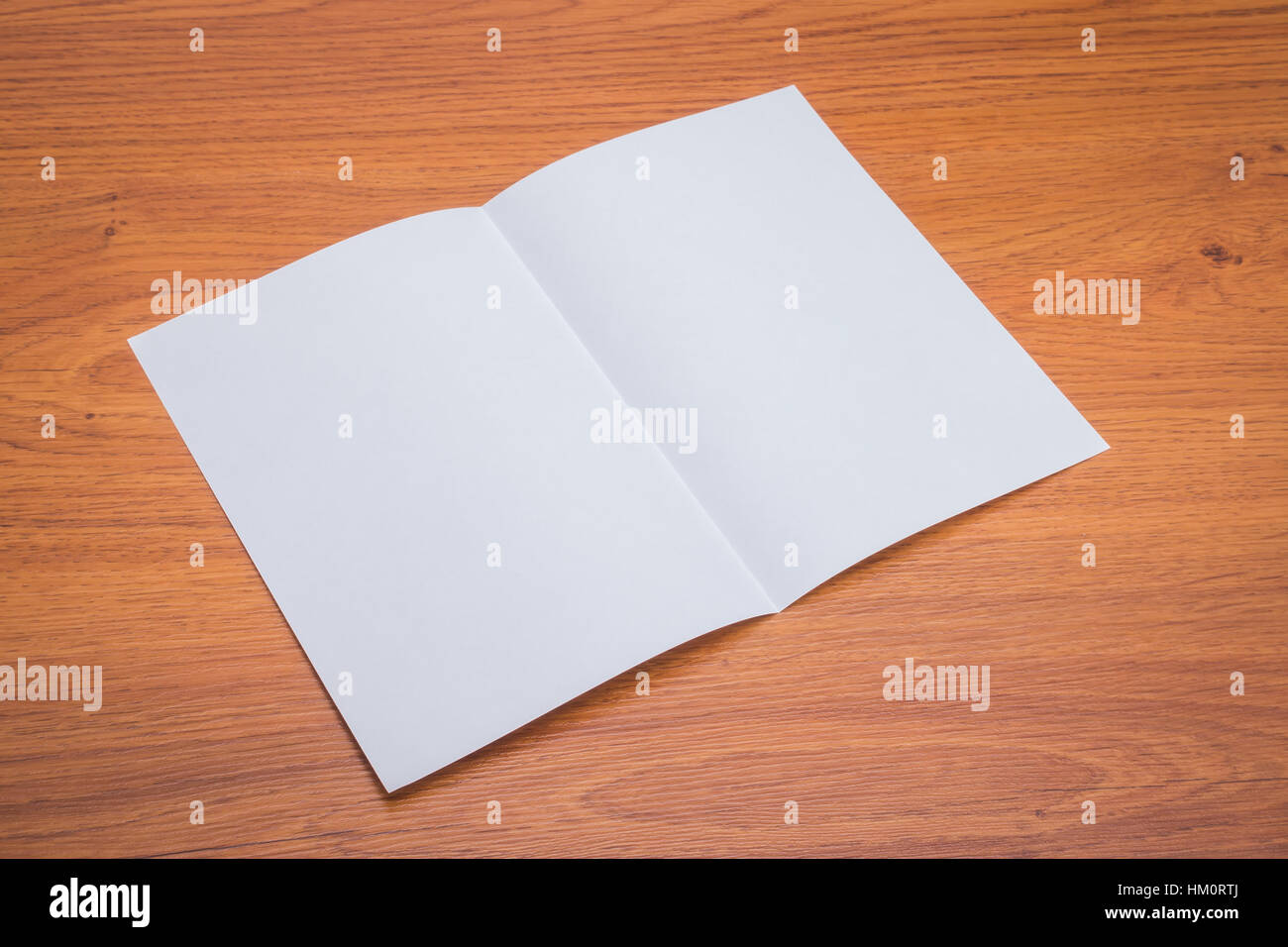Bifold white template paper on wood texture Stock Photo - Alamy