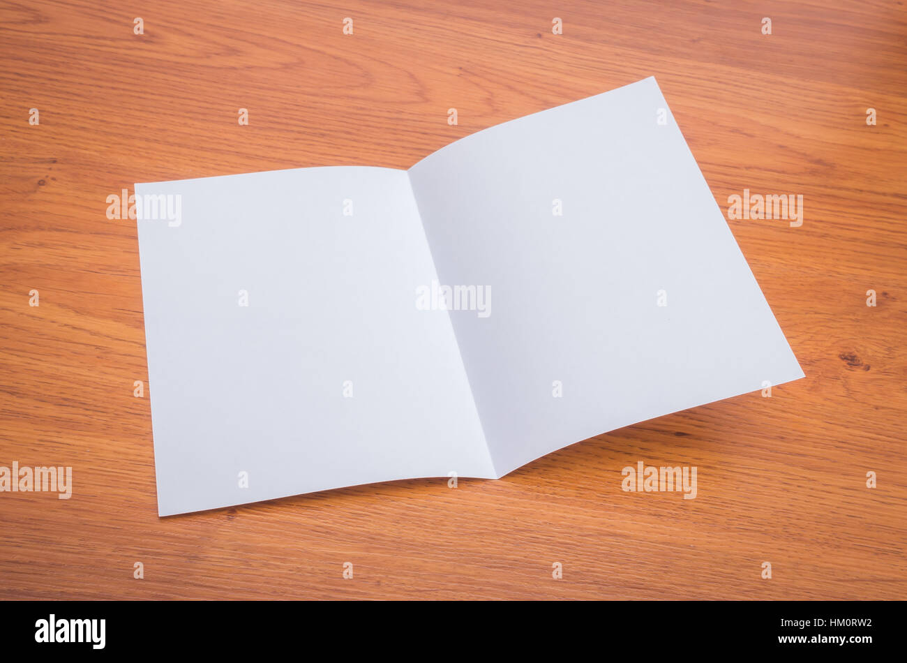 Bifold white template paper on wood texture Stock Photo - Alamy