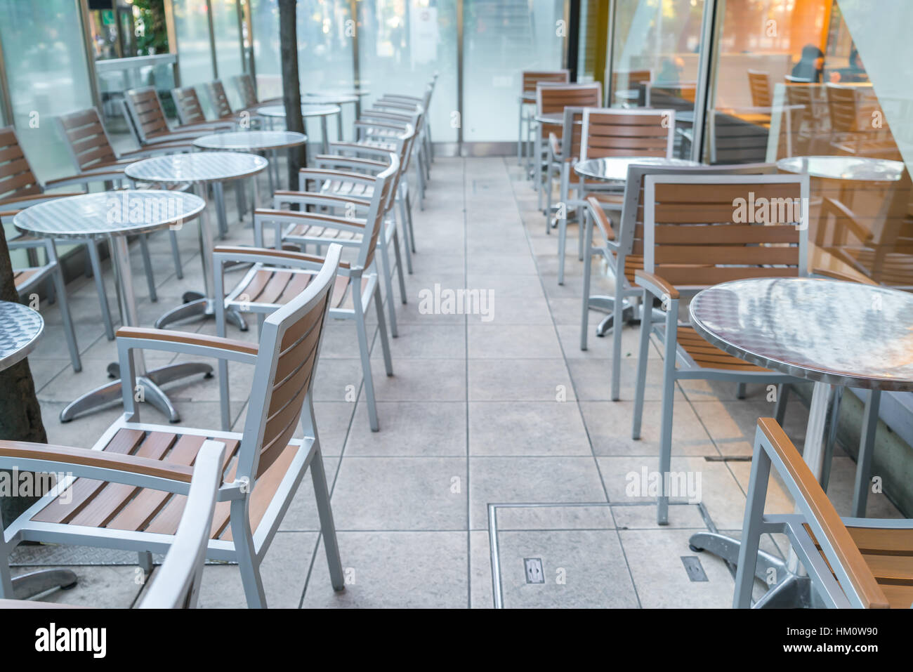 Tables and chairs in restaurant Stock Photo - Alamy