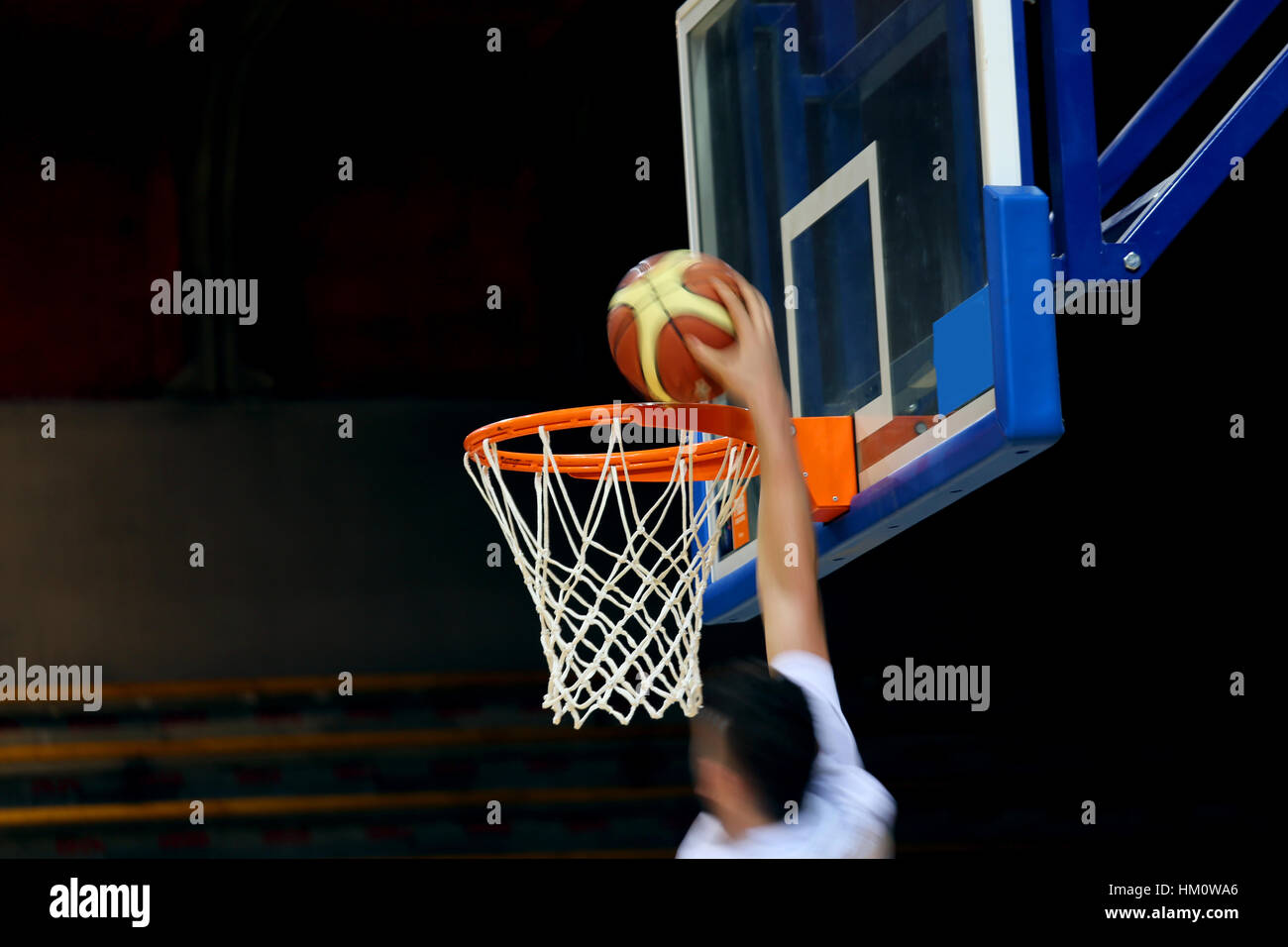 ball down through the basket with the hand above the rim Stock Photo ...