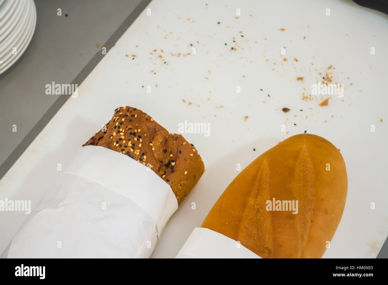 Fresh bread slice and cutting knife on table in buffet Stock Photo - Alamy