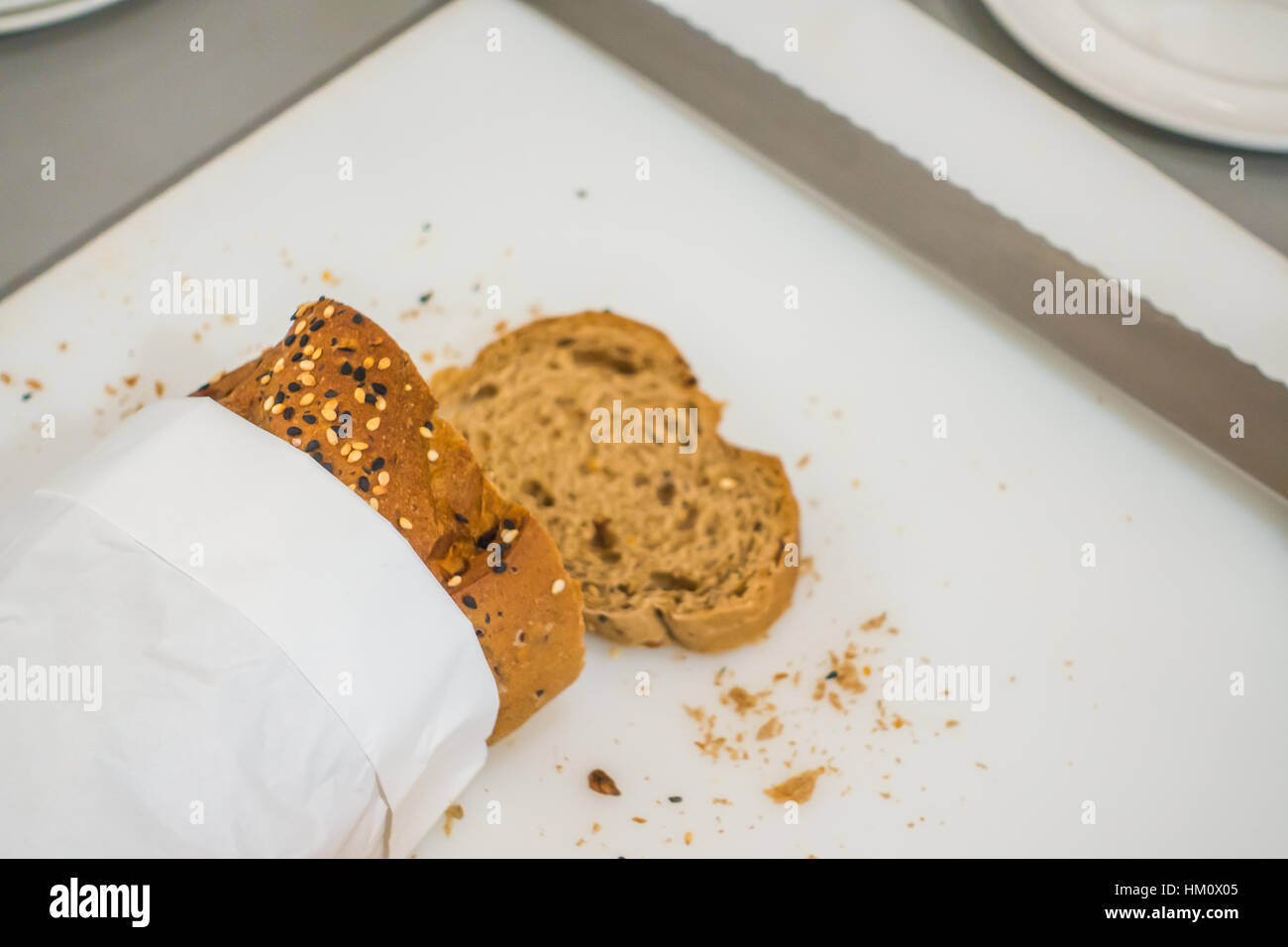 Fresh bread slice and cutting knife on table in buffet Stock Photo - Alamy