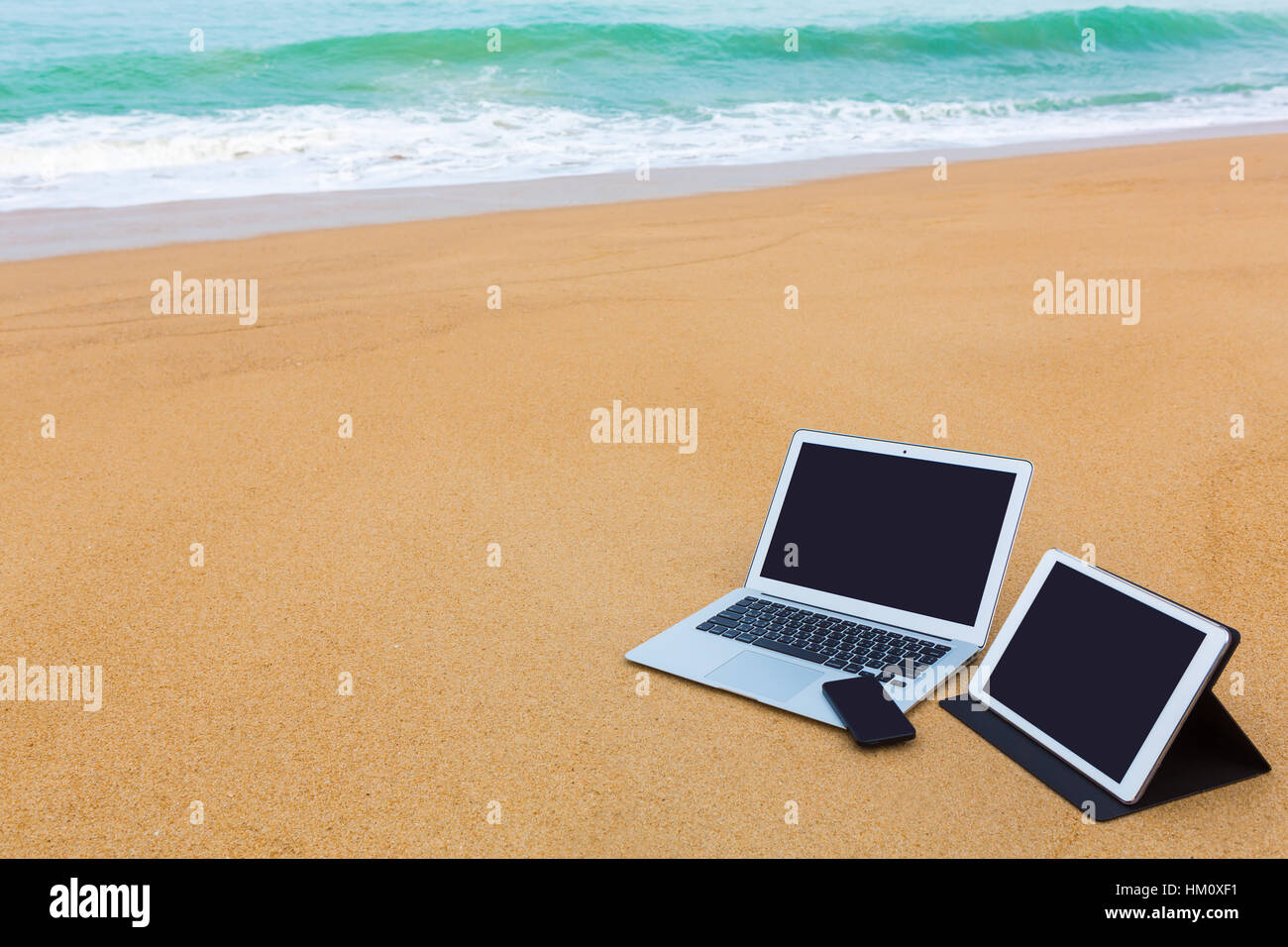 Laptop ,tablet and smartphone on the beach in summer time Stock Photo ...