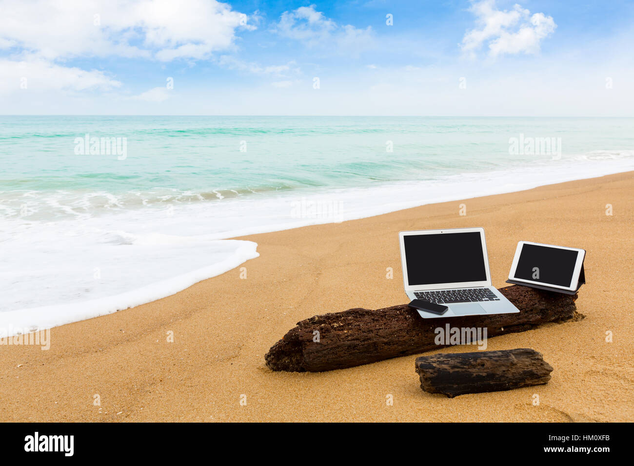 Laptop ,tablet and smartphone on the beach in summer time Stock Photo ...