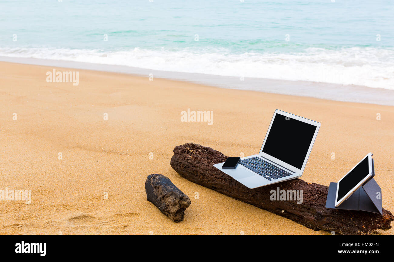 Laptop ,tablet and smartphone on the beach in summer time Stock Photo ...