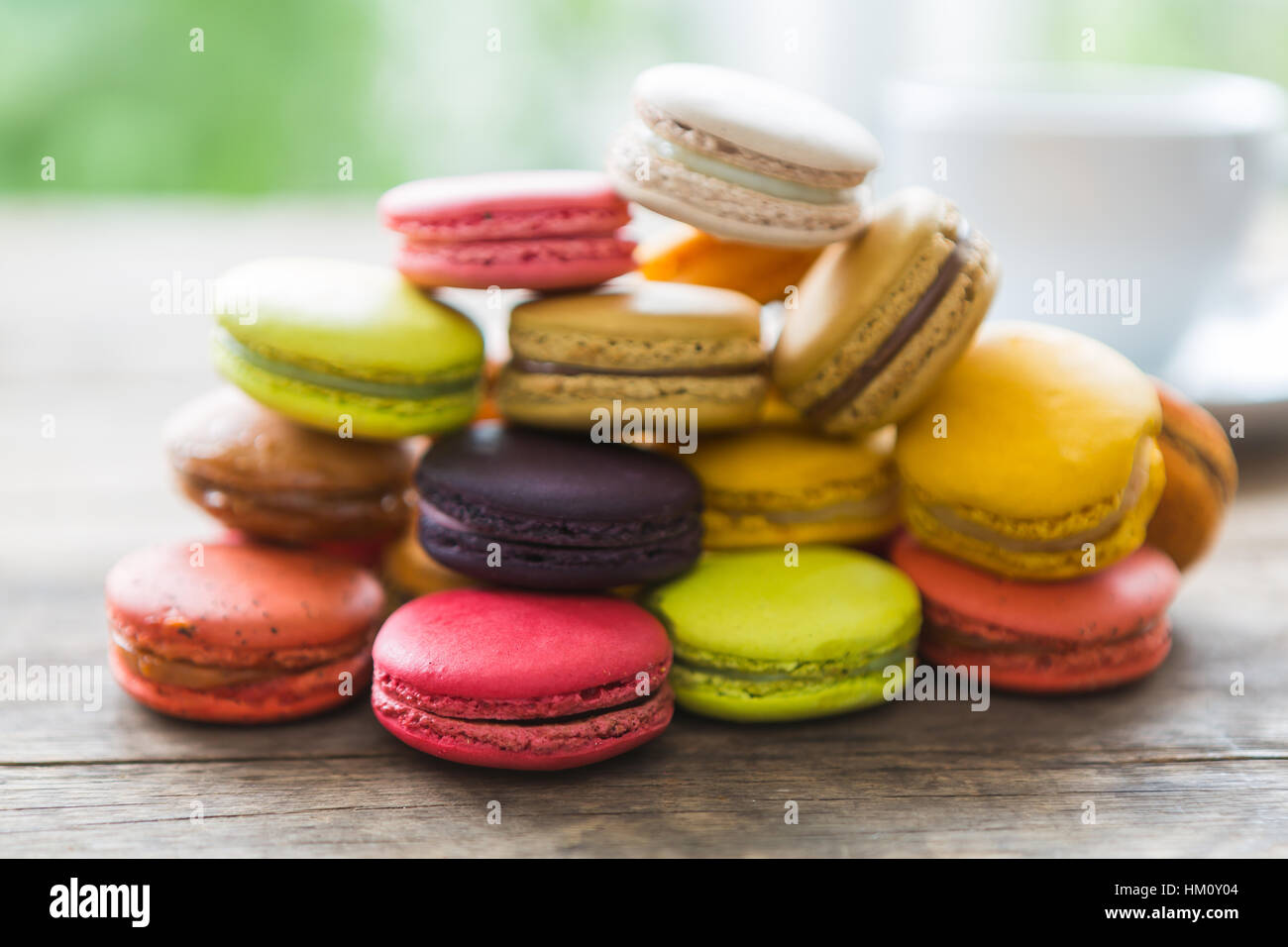 French colorful macarons on wood table Stock Photo - Alamy