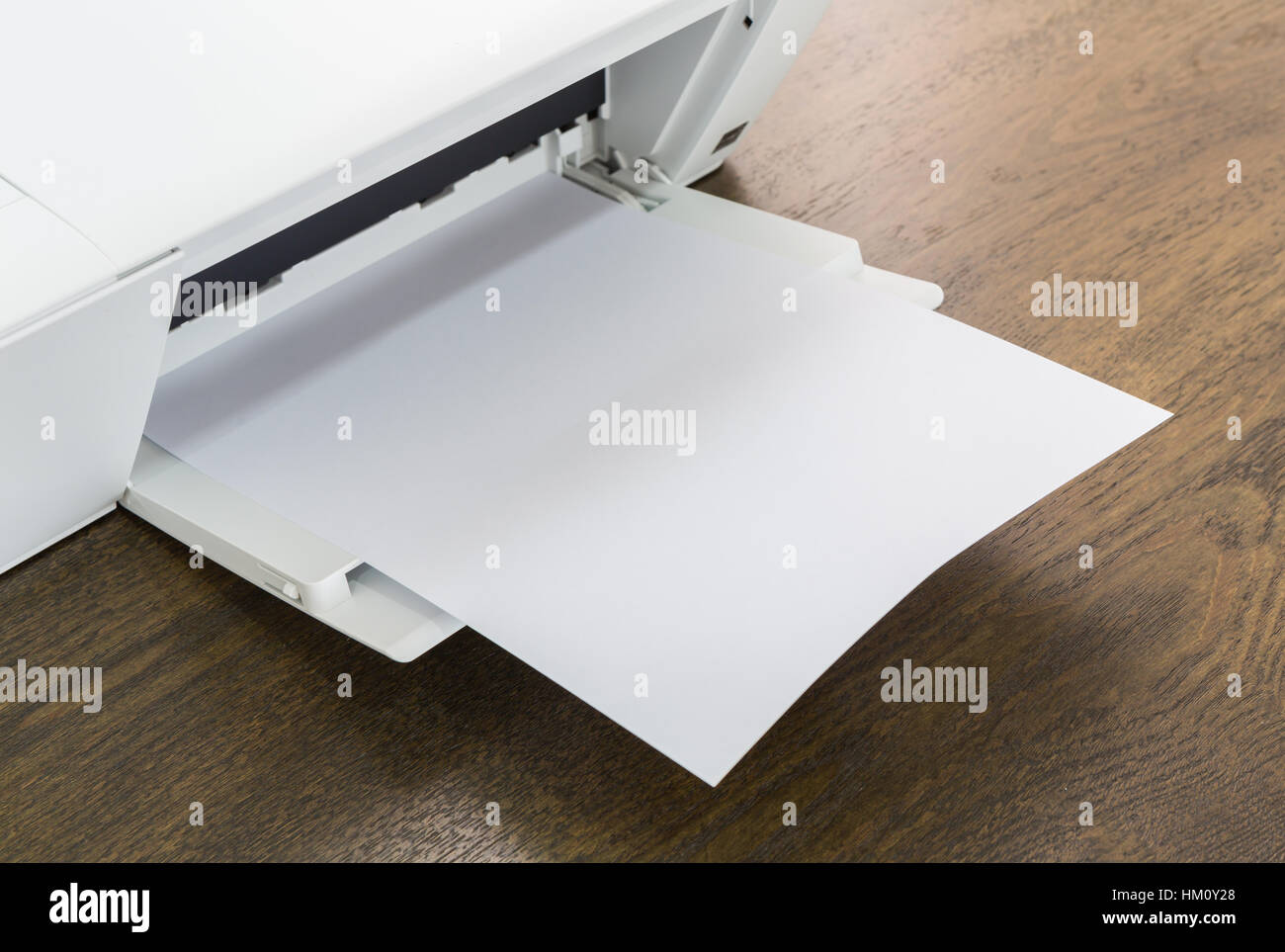 Printer with blank paper on a wood table Stock Photo - Alamy