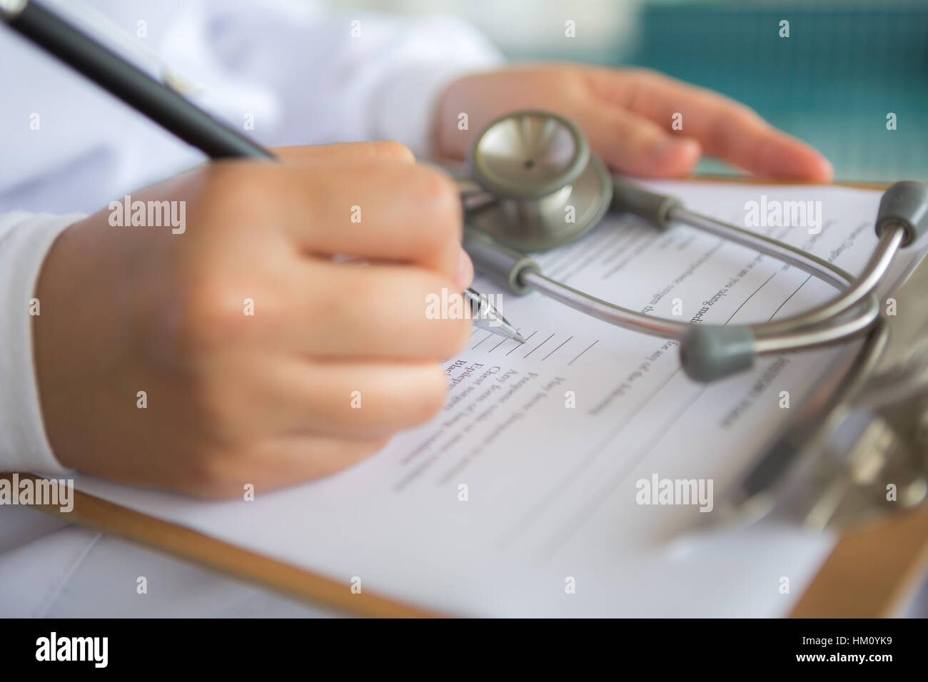 Hand of doctor writing on prescription Stock Photo - Alamy