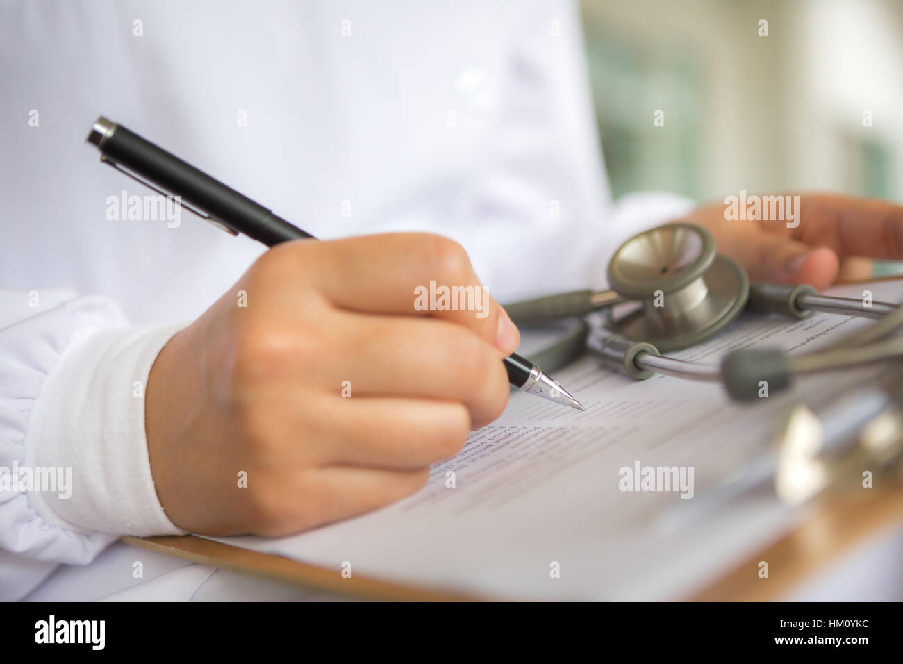 Hand of doctor writing on prescription Stock Photo - Alamy