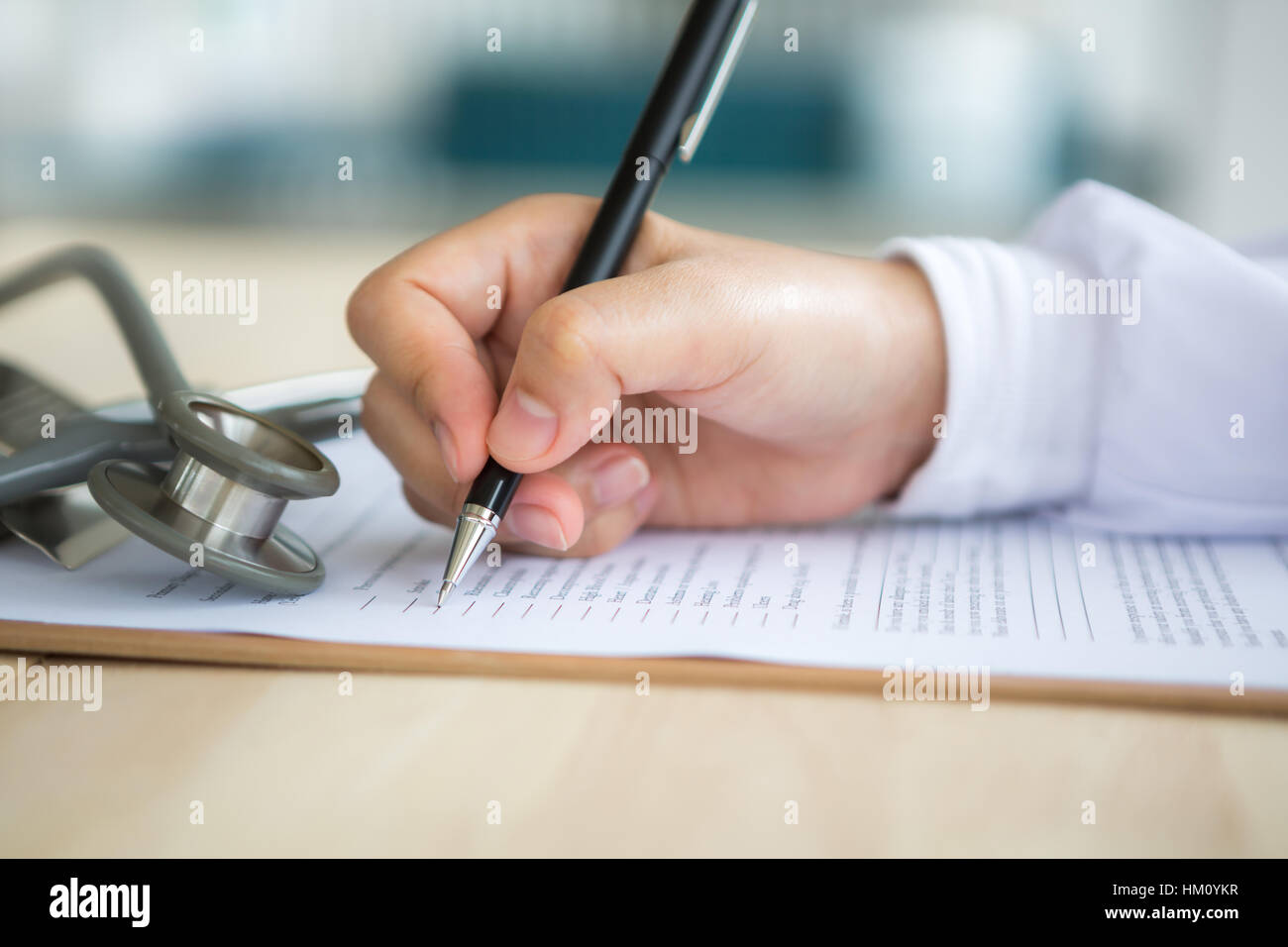 Hand of doctor writing on prescription Stock Photo - Alamy