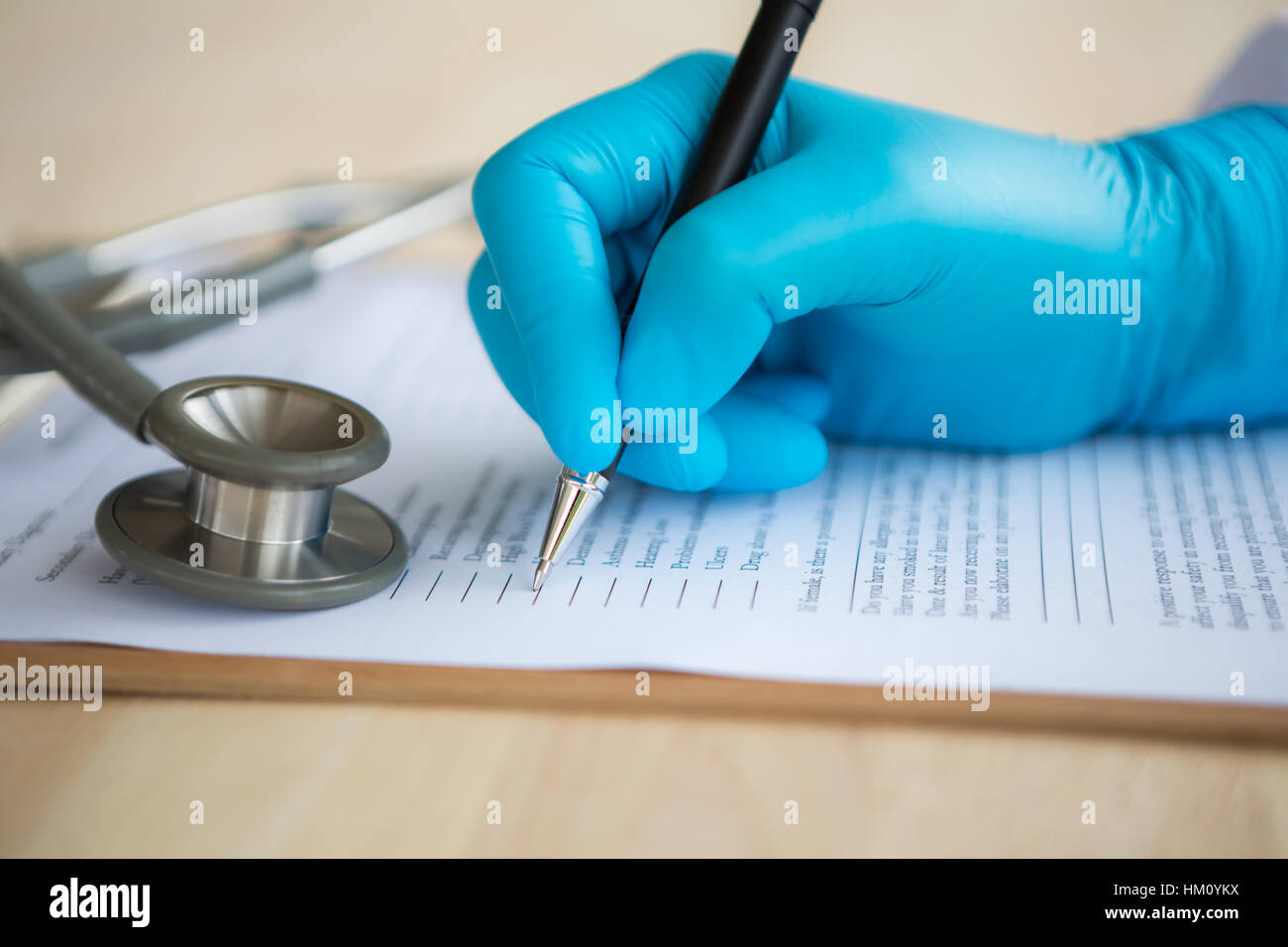 Hand of doctor writing on prescription Stock Photo - Alamy