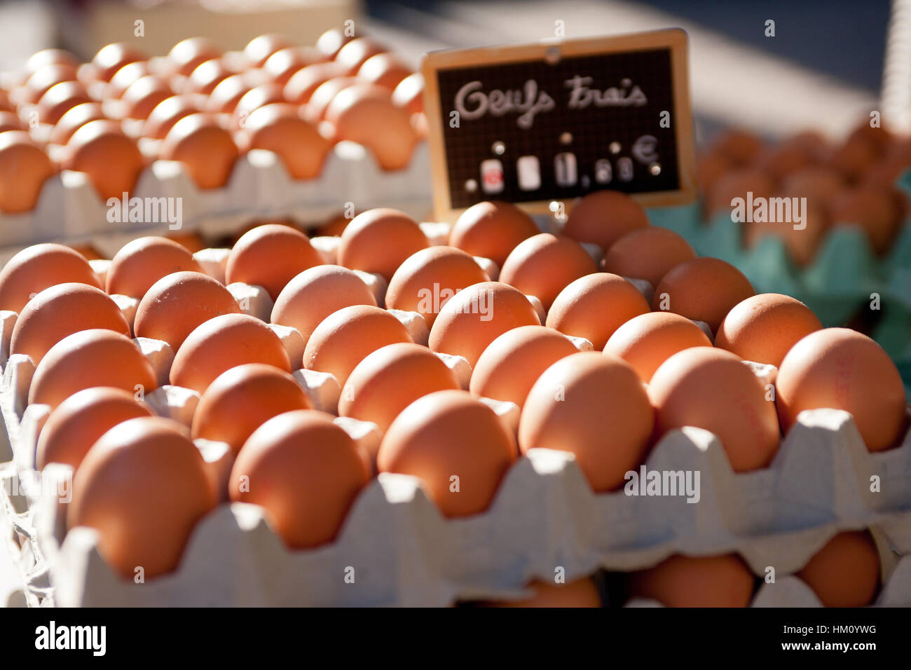 Stacked Fresh Farm Eggs on a French Market in early morning sunshine ...