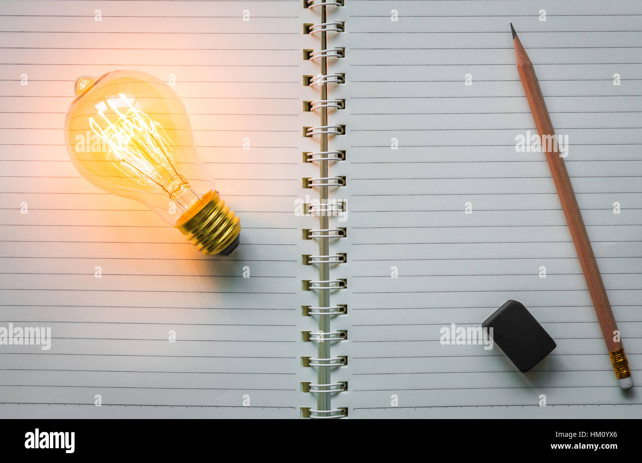 Note book and light bulb Stock Photo - Alamy