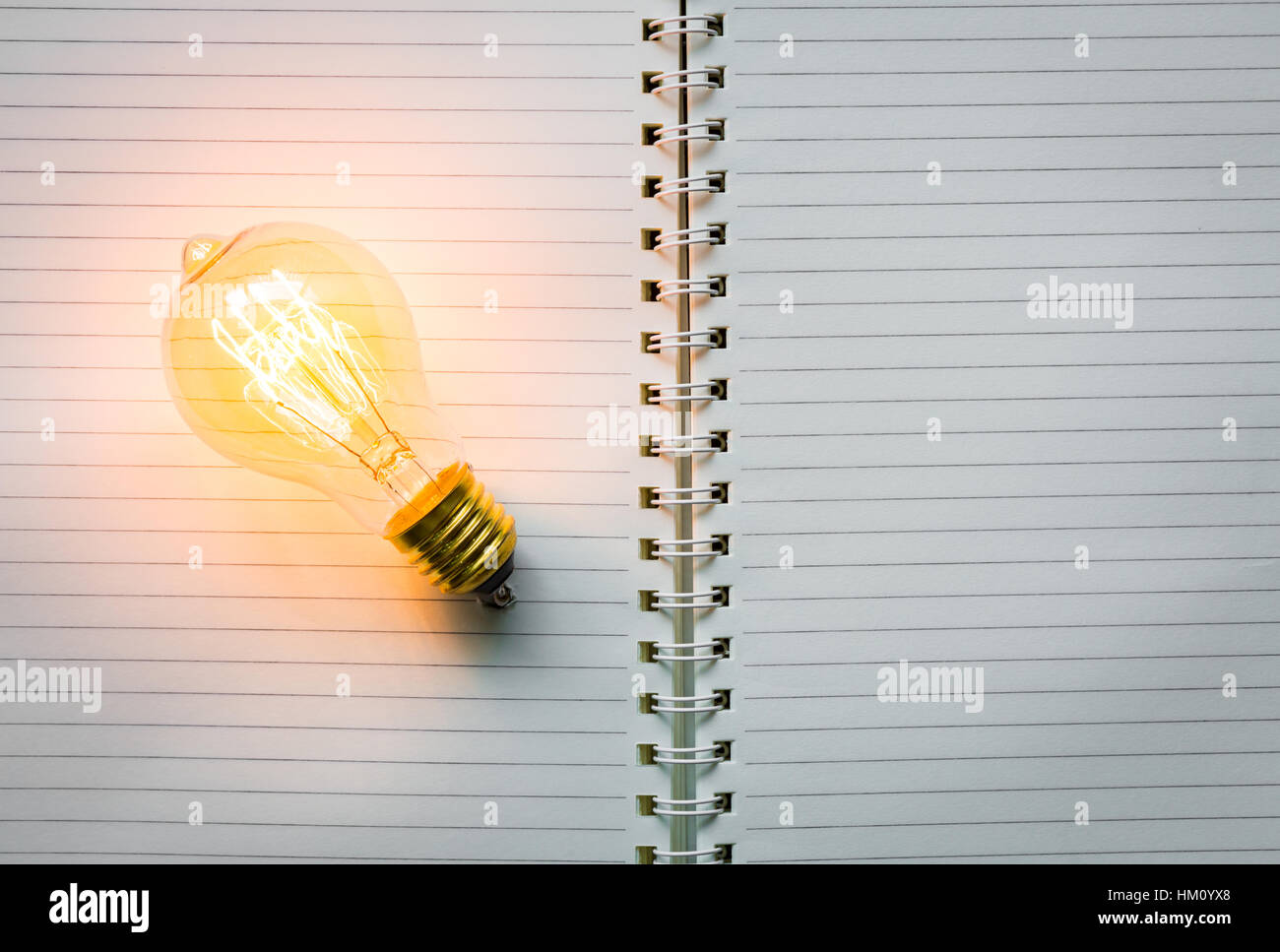 Note book and light bulb Stock Photo - Alamy