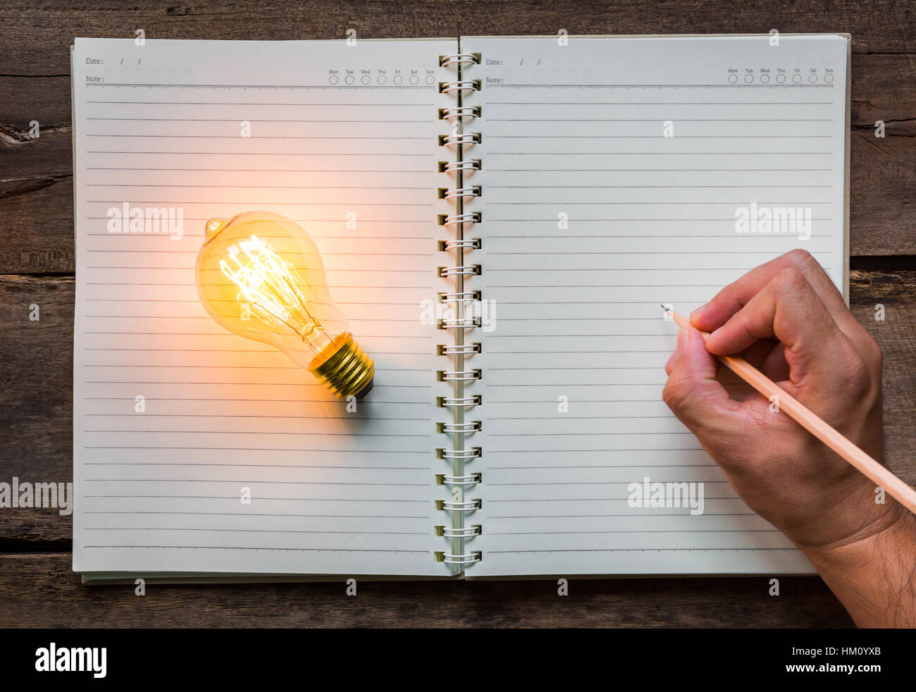 Hand write over Note book and light bulb Stock Photo - Alamy