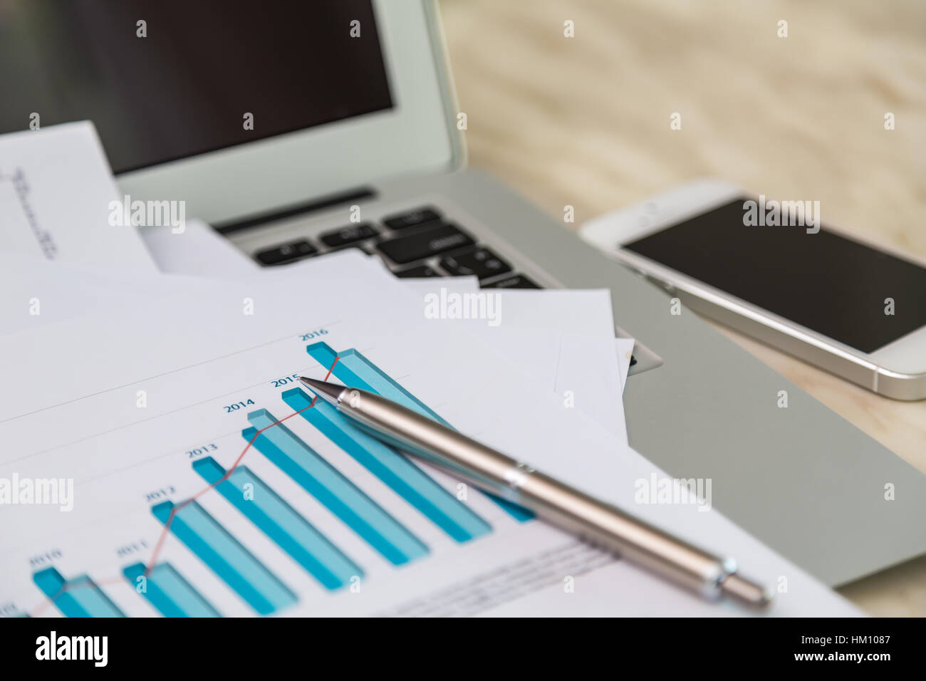 Financial charts on the table with laptop Stock Photo - Alamy
