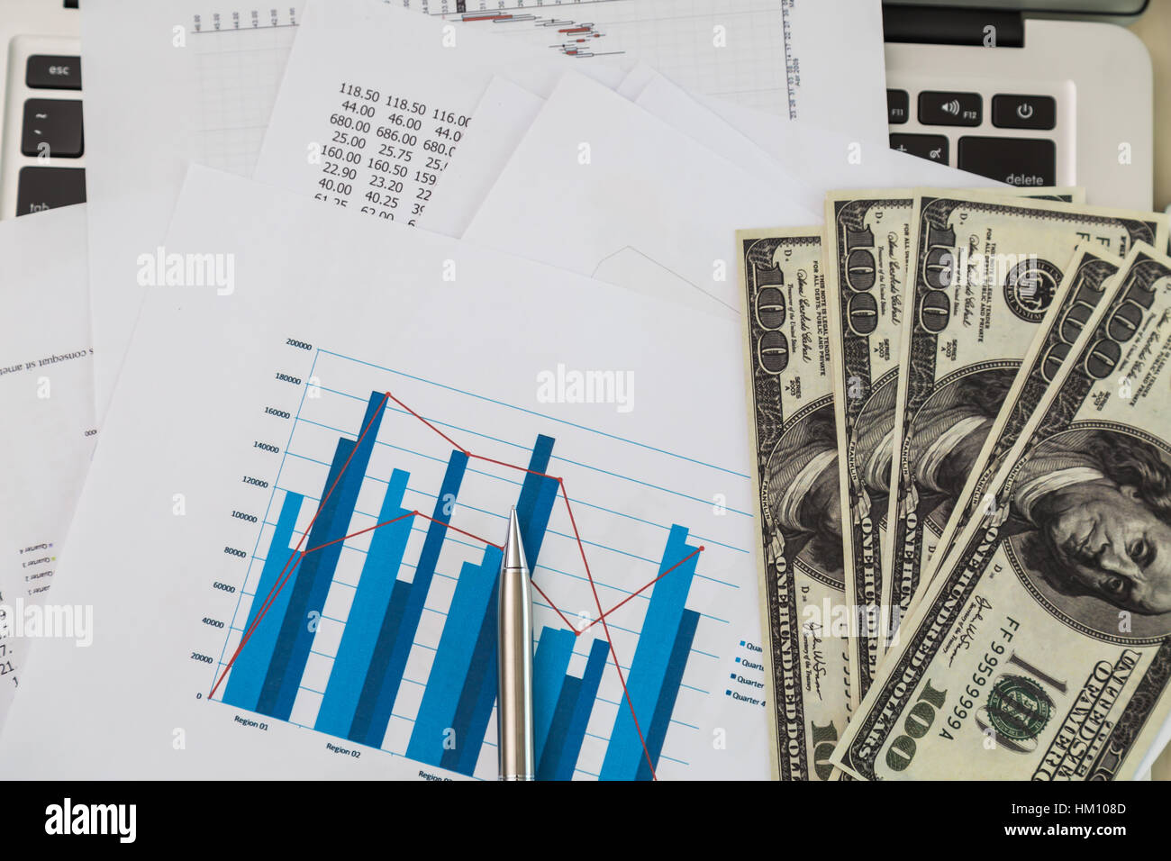 Financial charts on the table with laptop Stock Photo - Alamy