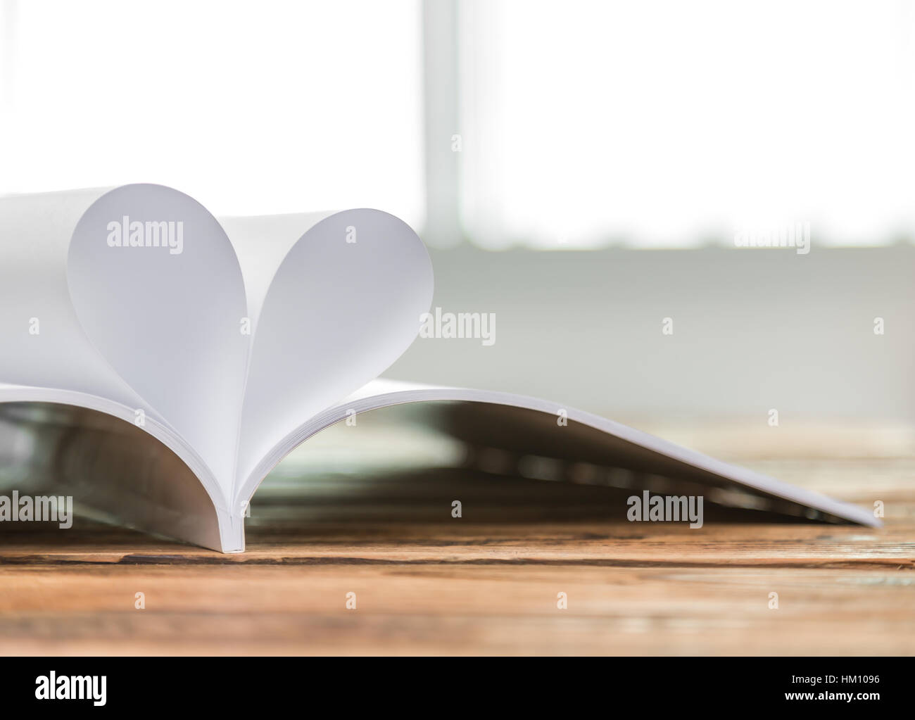 Book with opened pages of shape of heart Stock Photo - Alamy