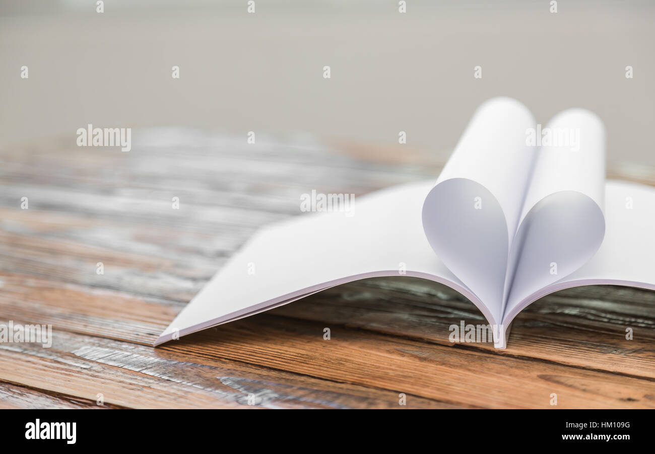 Book with opened pages of shape of heart Stock Photo - Alamy