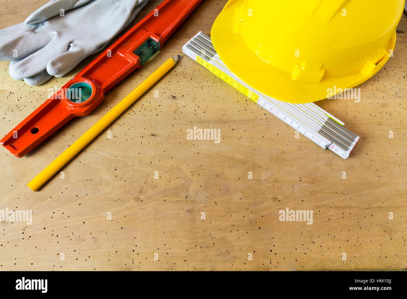 Protective helmet and mason tools on wood background Stock Photo - Alamy