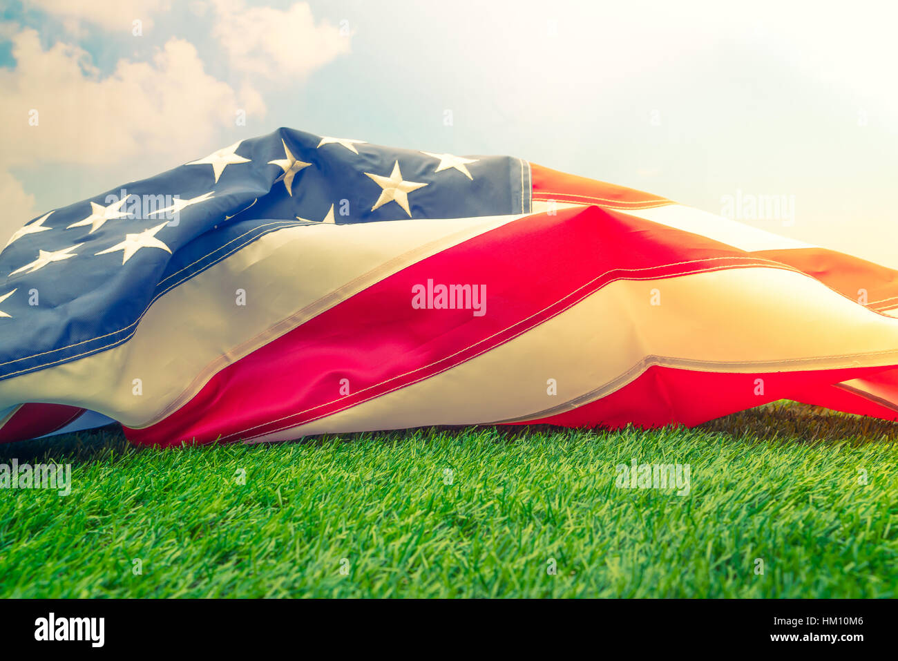 American flag on green grass ( Filtered image processed vintage effect ...