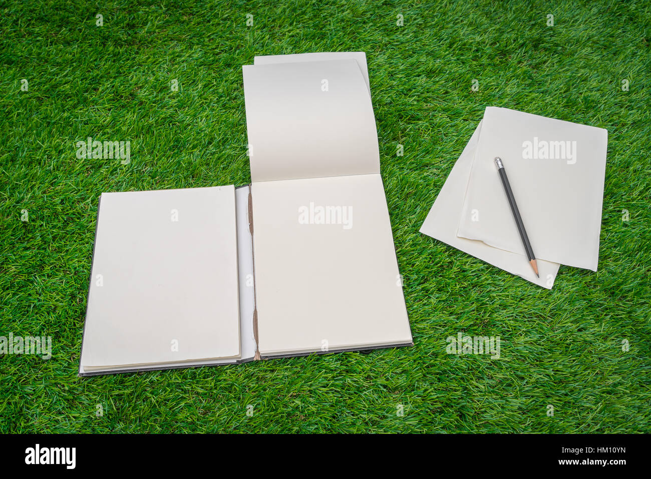 Notebook on spring green grass Stock Photo - Alamy