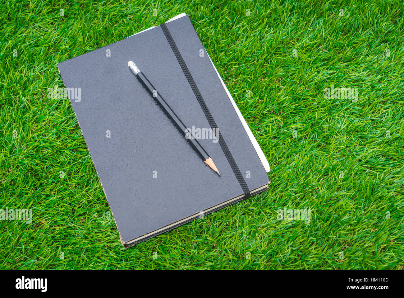 Notebook on spring green grass Stock Photo - Alamy