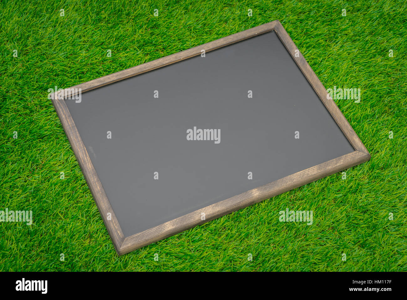 Blank black board on grass field Stock Photo - Alamy