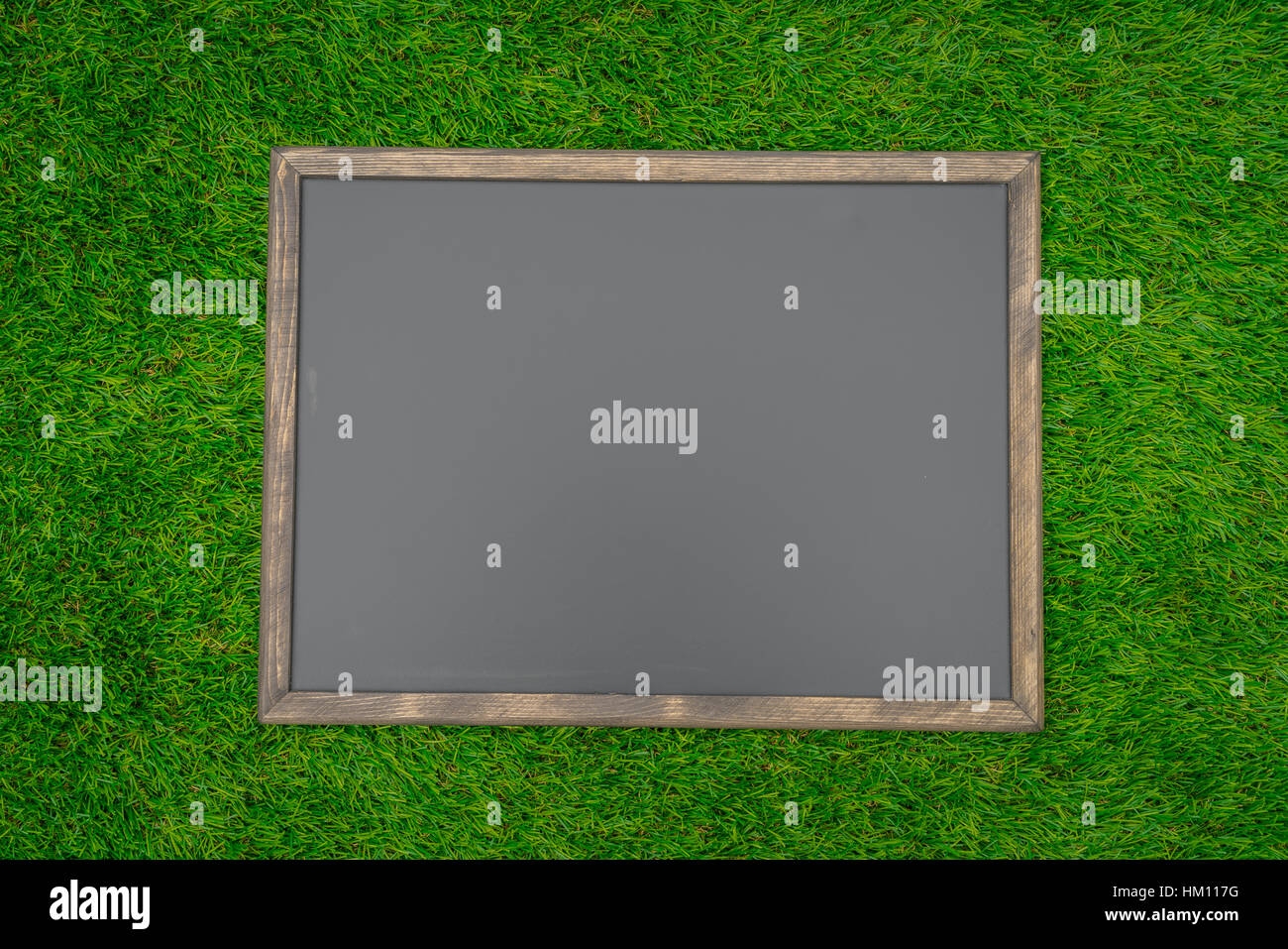 Blank black board on grass field Stock Photo - Alamy